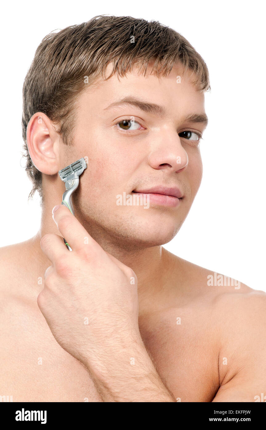 Portrait of a young handsome man shaving Stock Photo - Alamy