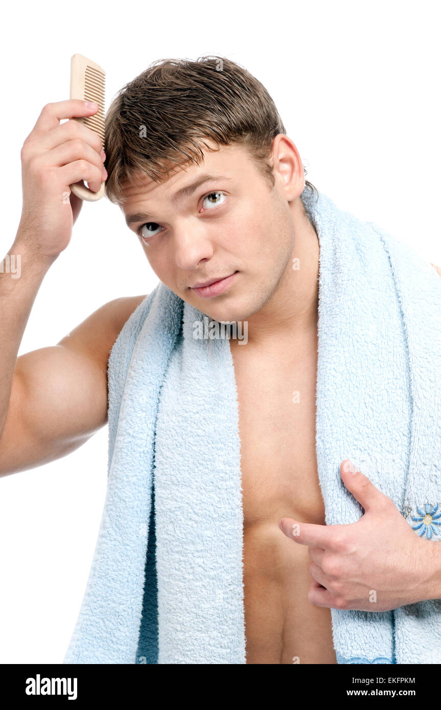 Young man combing his hair Stock Photo - Alamy
