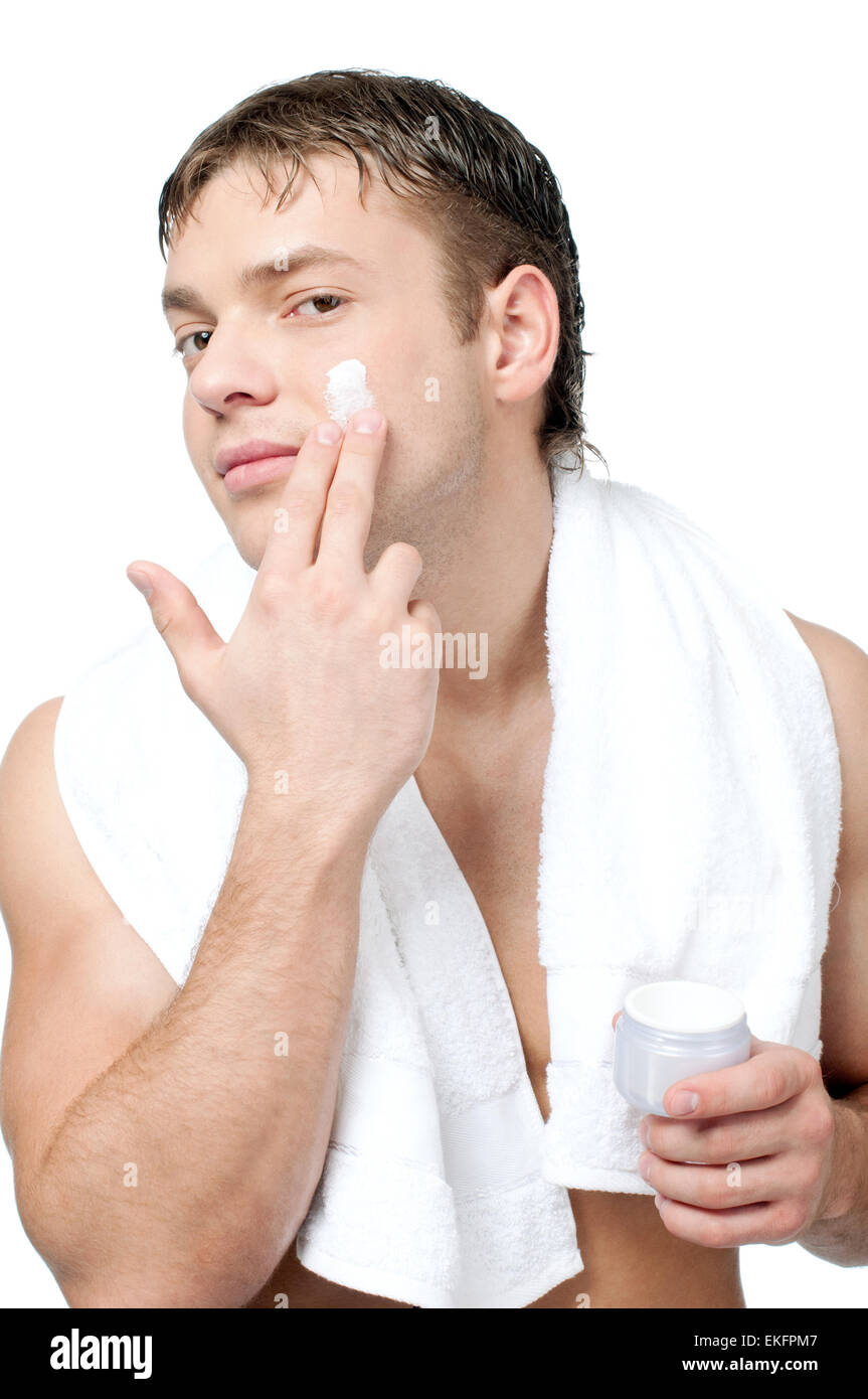 Man putting on cream lotion on face Stock Photo - Alamy