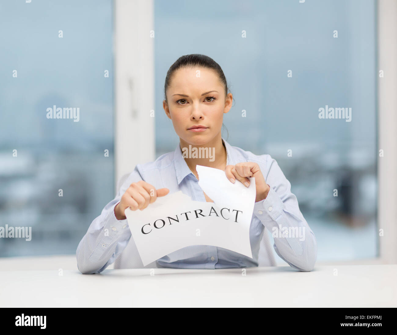 serious businesswoman tearing contract Stock Photo - Alamy