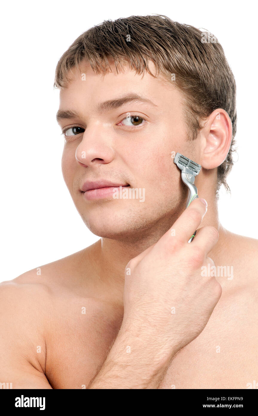 Portrait of a young handsome man shaving Stock Photo - Alamy