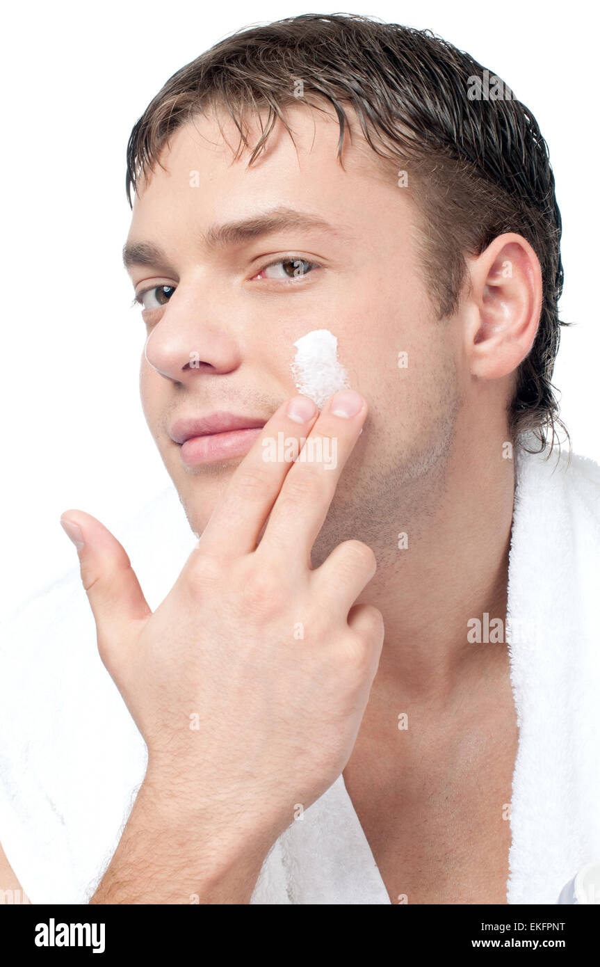 Man putting on cream lotion on face Stock Photo - Alamy