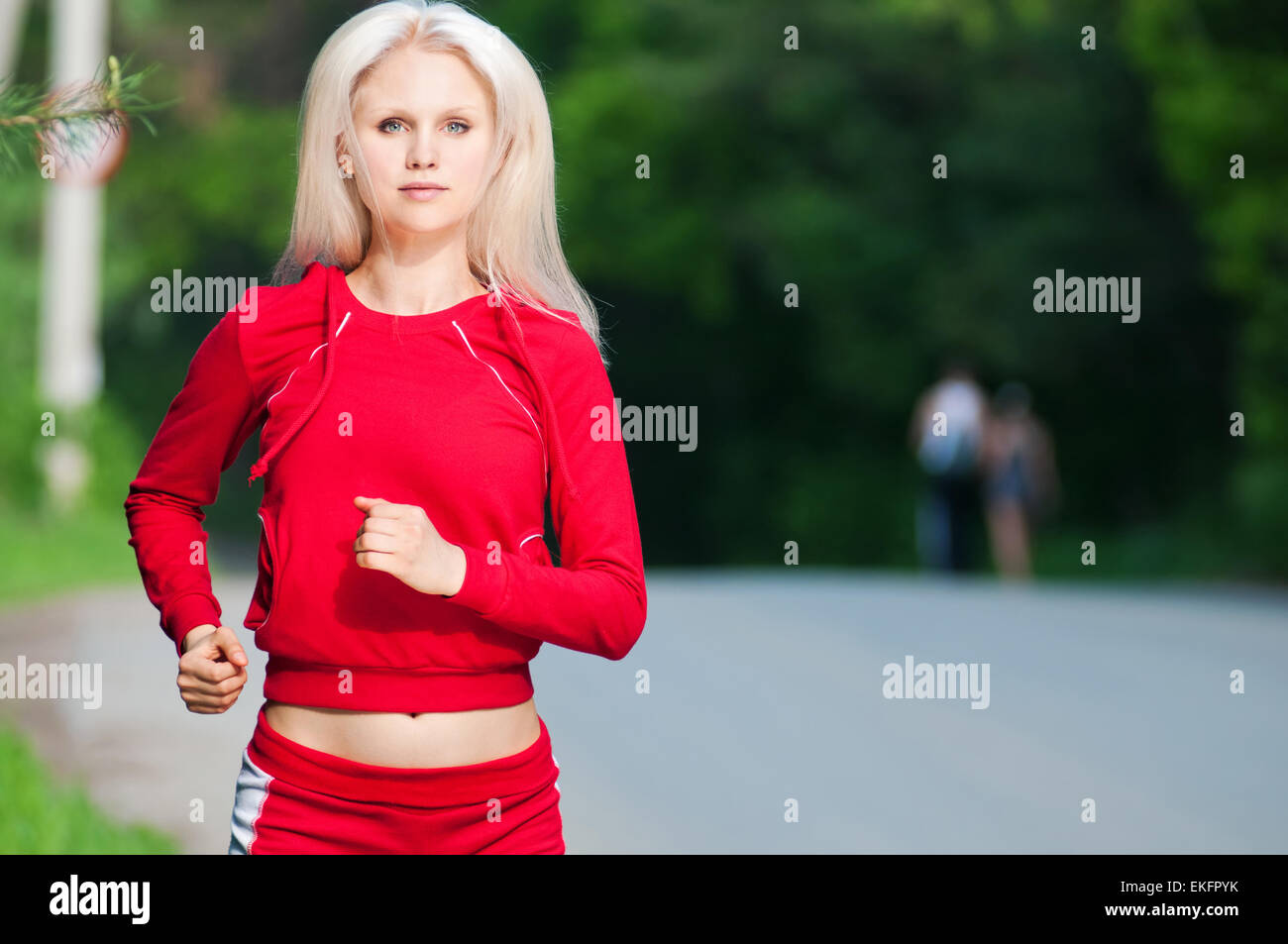 Beautiful woman running in park Stock Photo - Alamy