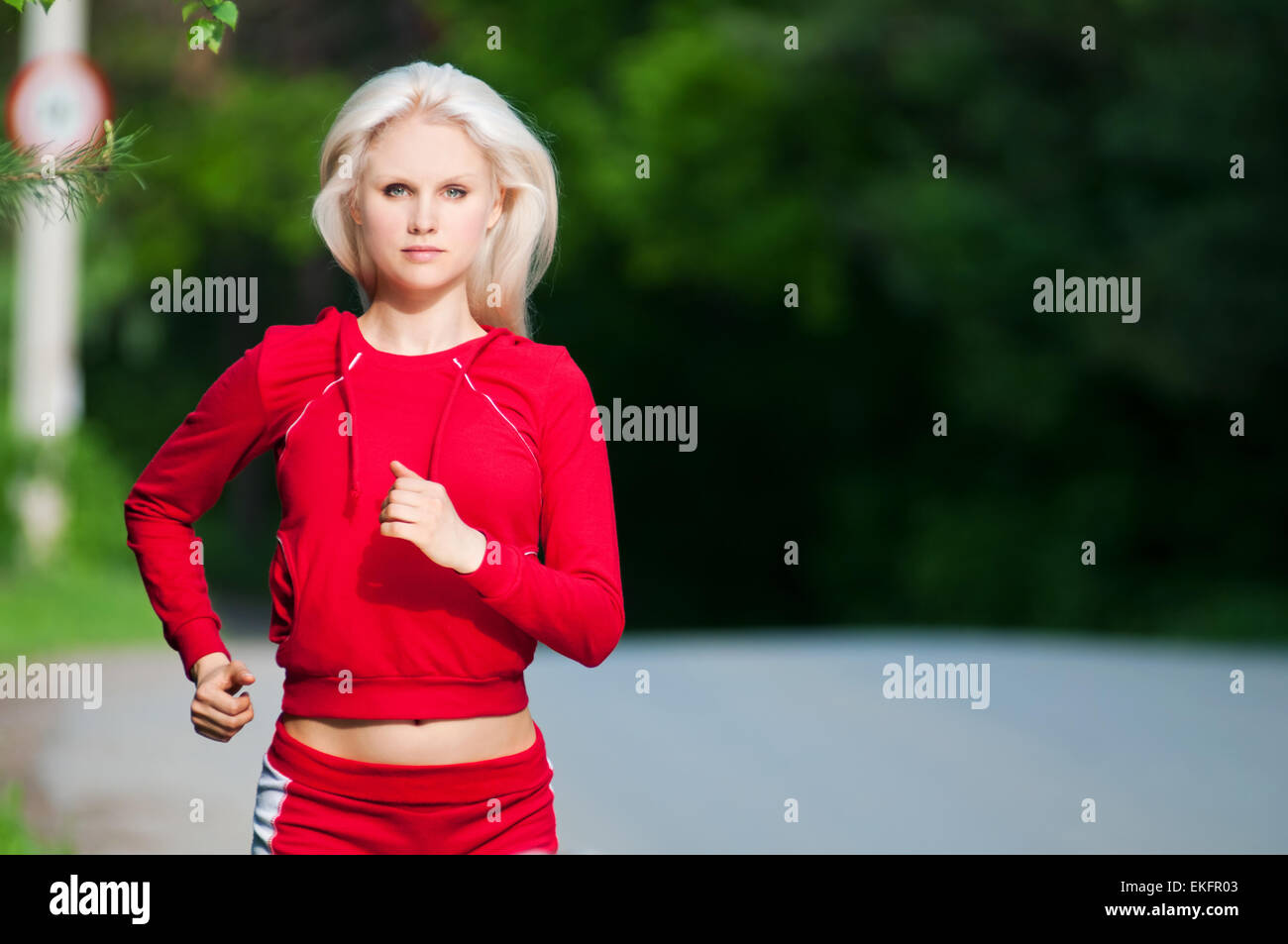 Beautiful woman running in park Stock Photo - Alamy
