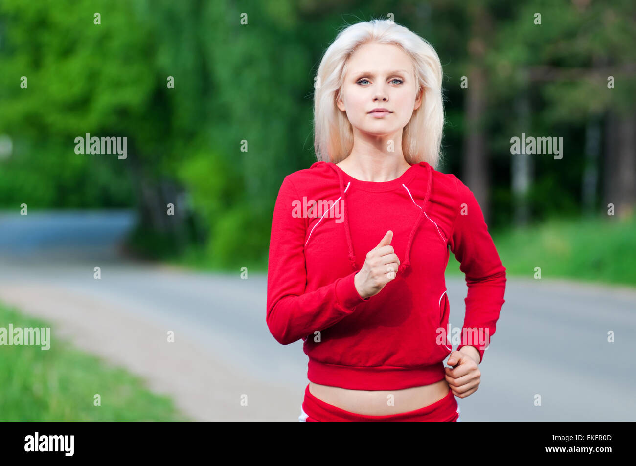 Beautiful woman running in park Stock Photo - Alamy