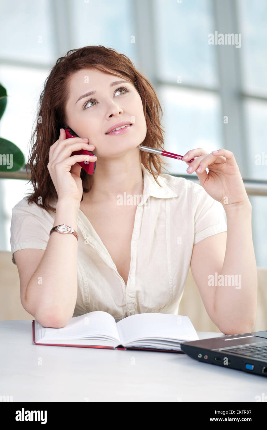 Business woman on phone taking notes Stock Photo - Alamy