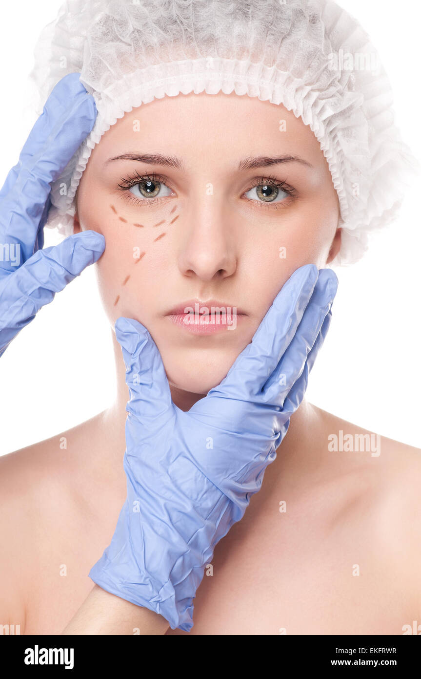 Beautician draw correction lines on woman face Stock Photo - Alamy