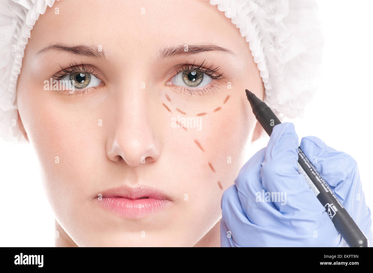 Beautician draw correction lines on woman face Stock Photo - Alamy