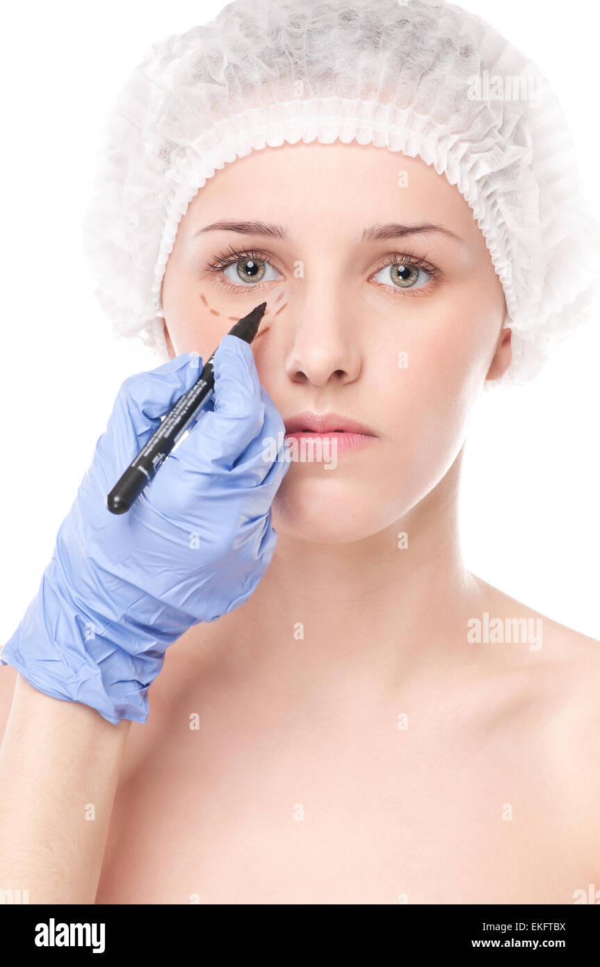 Beautician draw correction lines on woman face Stock Photo - Alamy