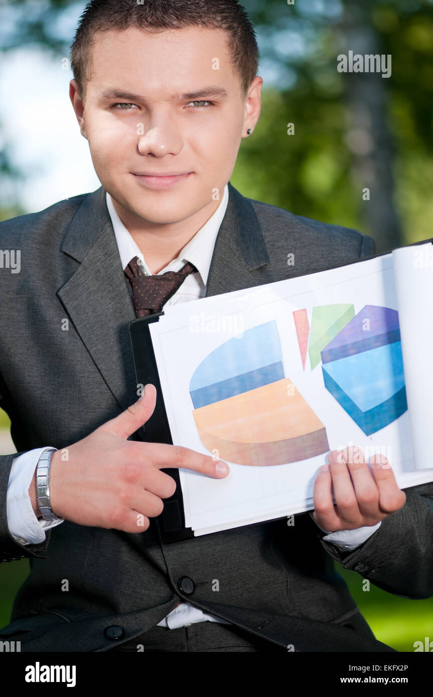 business man show graph at park. Student Stock Photo - Alamy