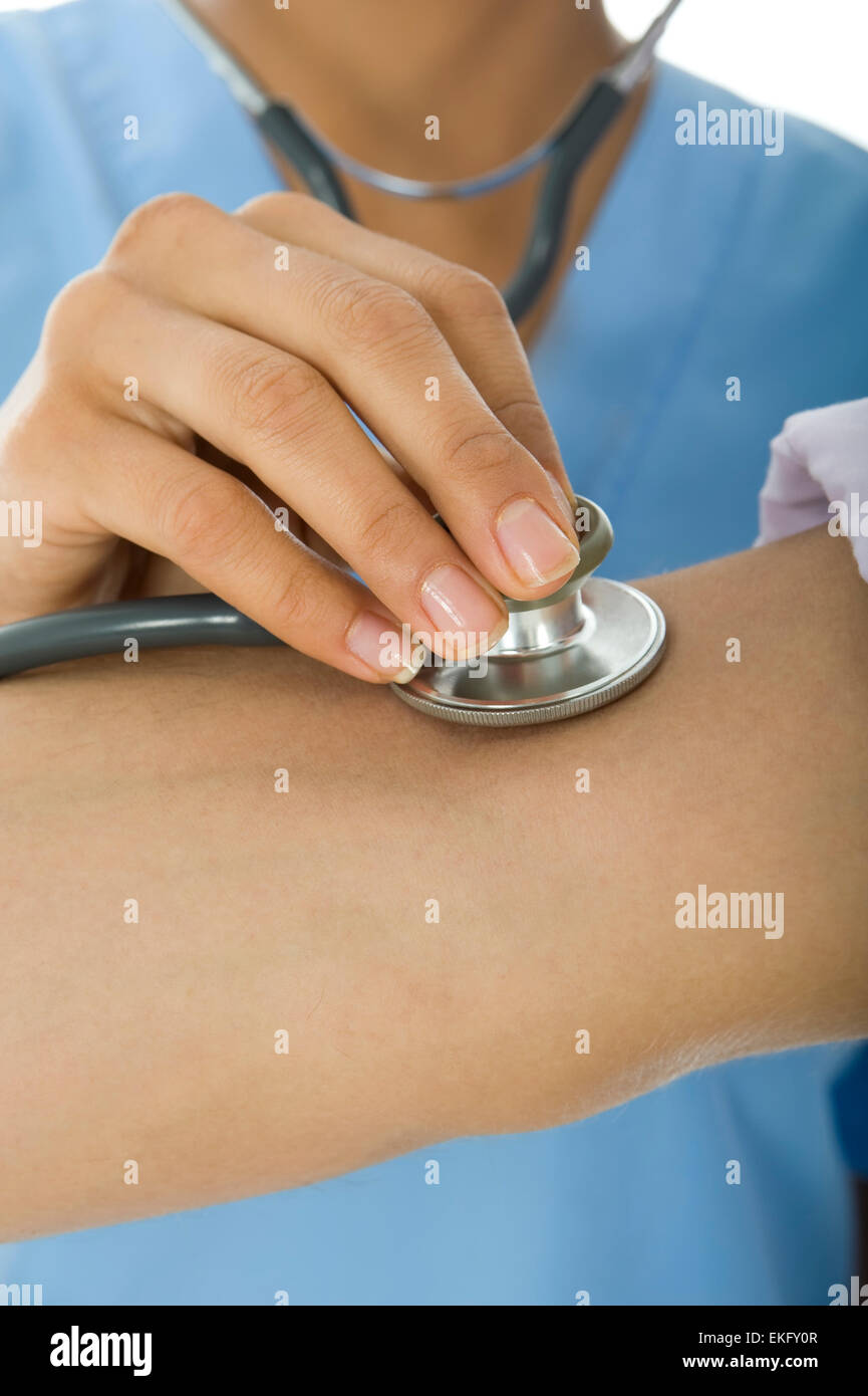 Female paramedic checking blood pressure hi-res stock photography and ...