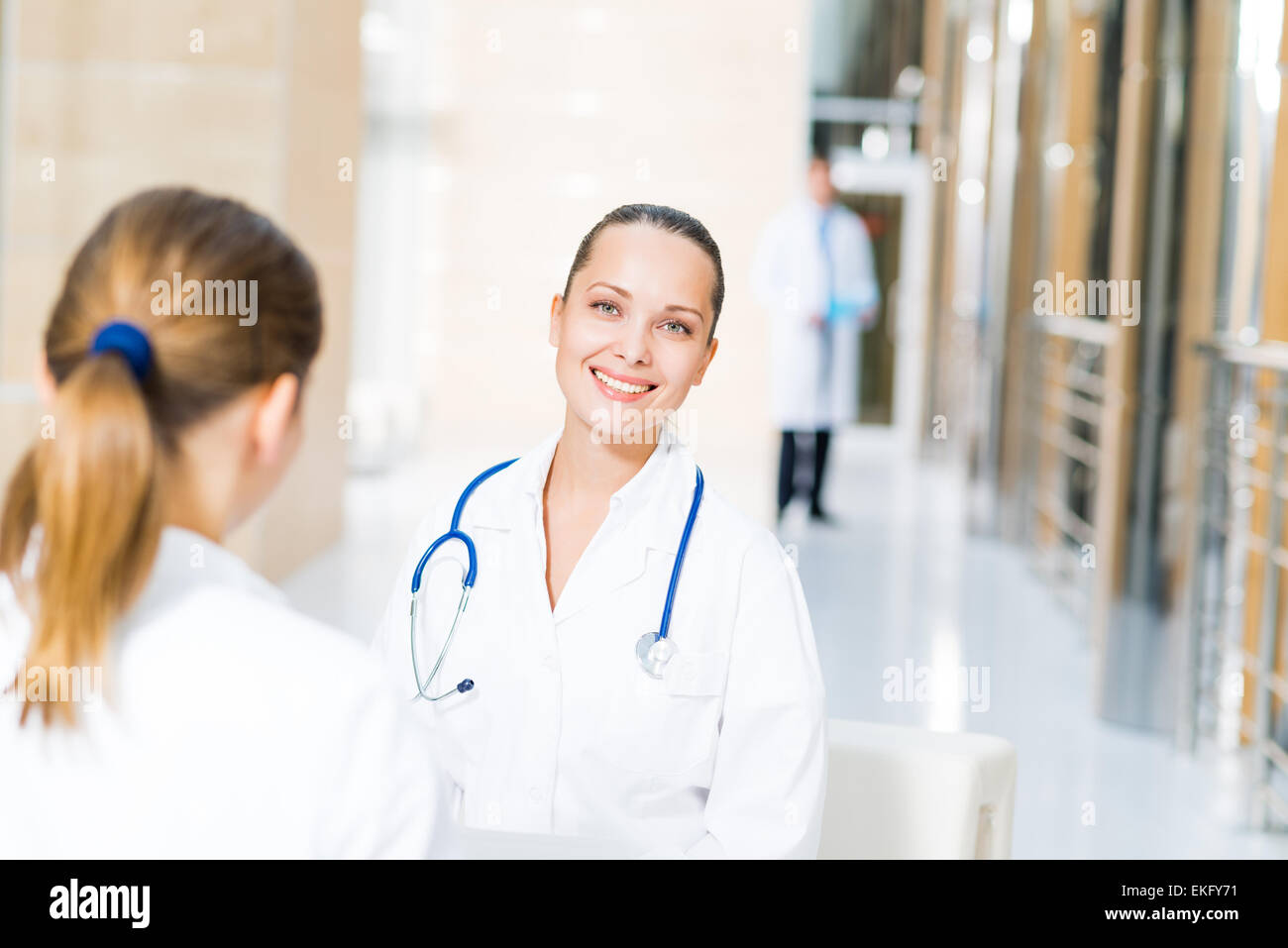 two doctors talking in the lobby Stock Photo - Alamy