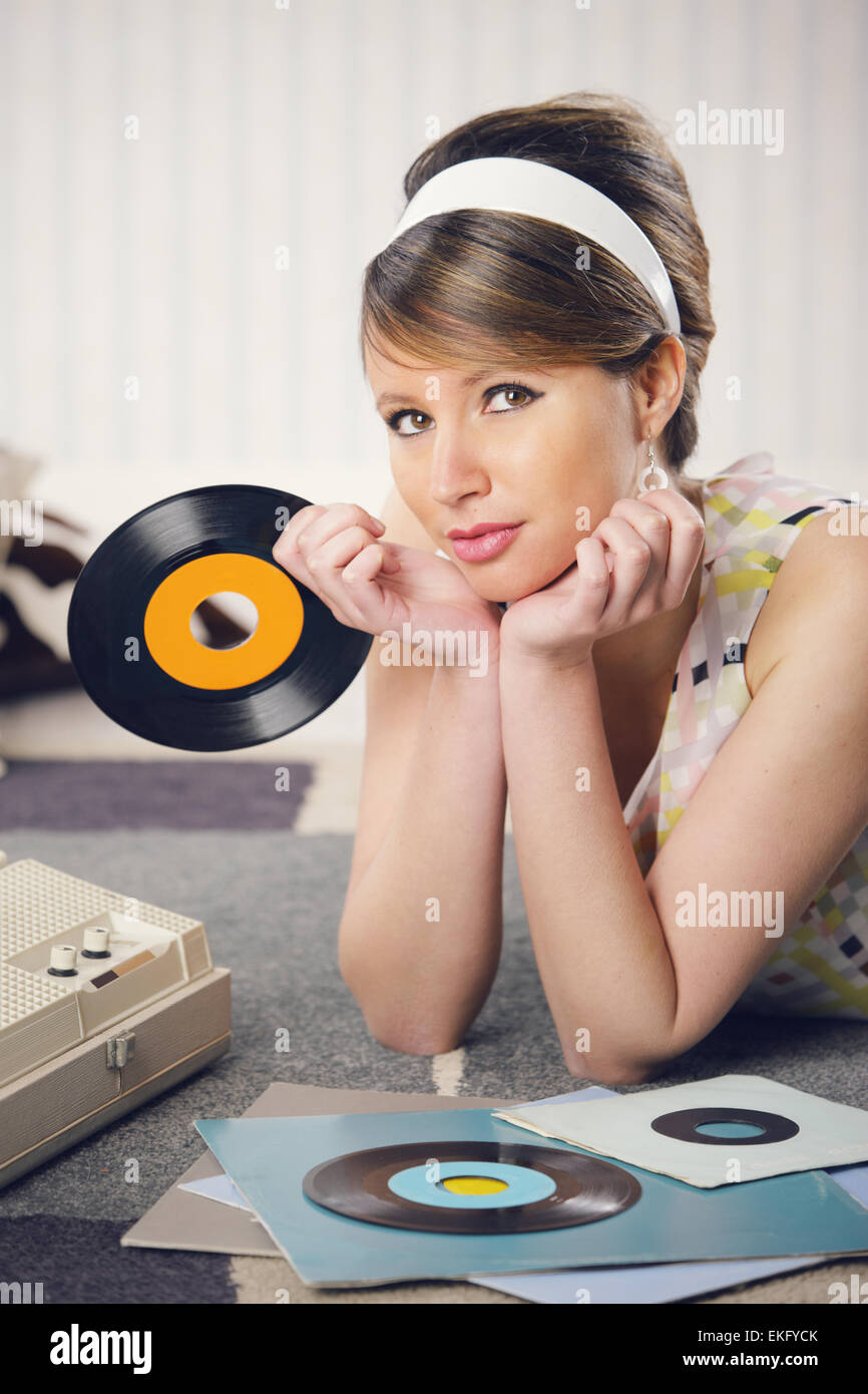 A woman listening to a record Stock Photo - Alamy