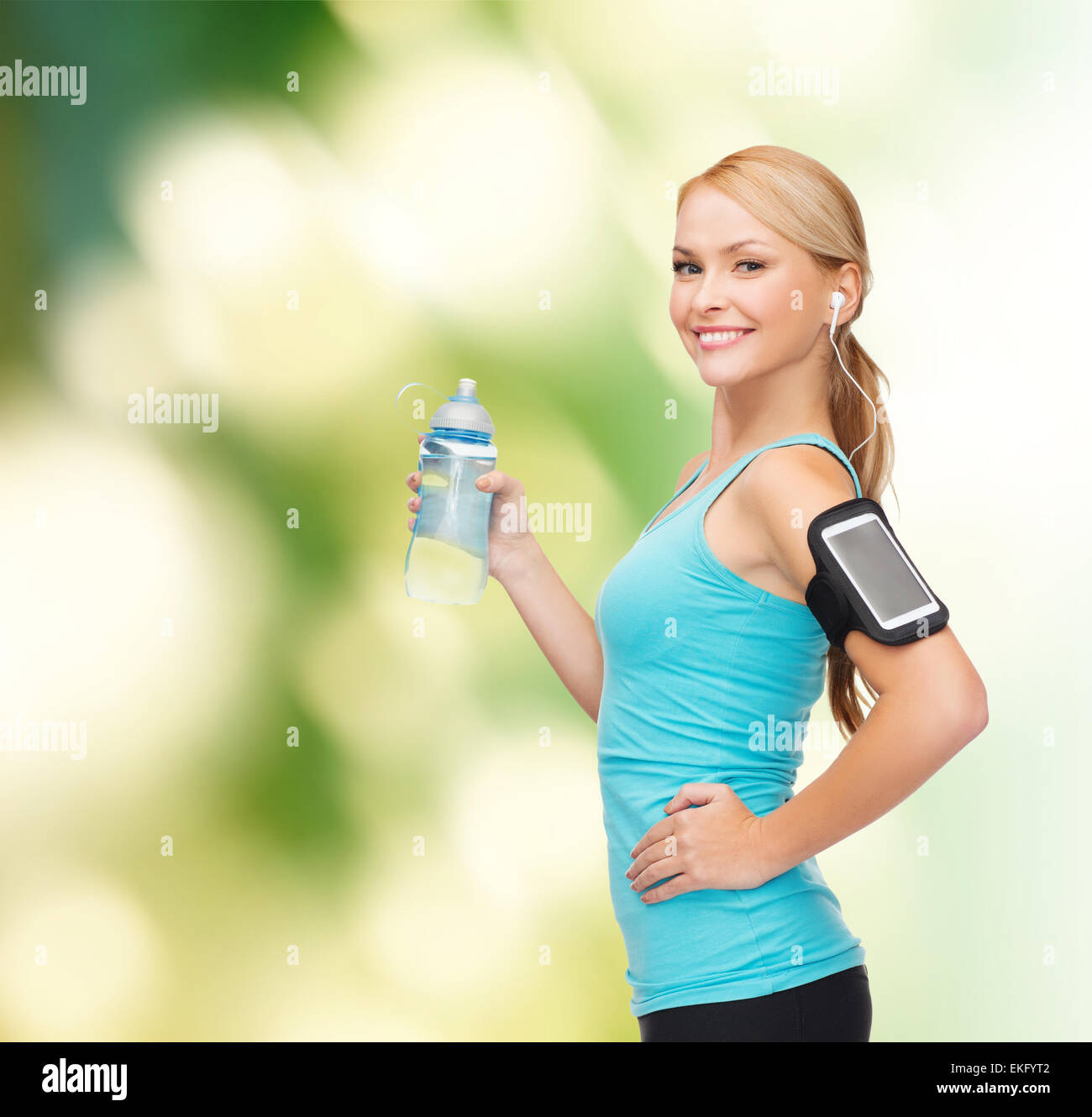 sporty woman running with smartphone and earphones Stock Photo - Alamy