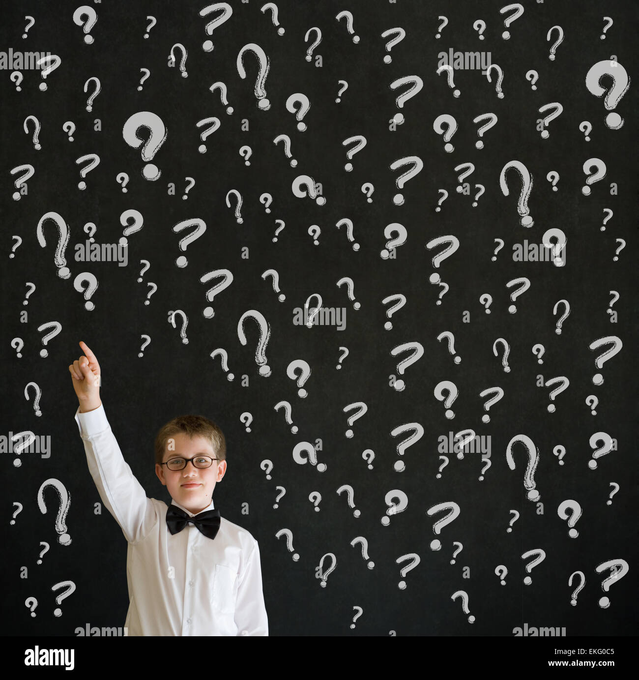 Hand up answer boy dressed as business man with chalk question marks ...