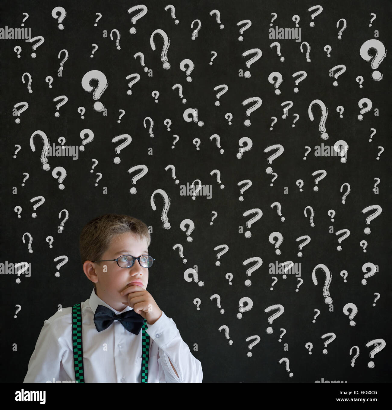 Thinking boy dressed as business man with chalk question marks Stock ...