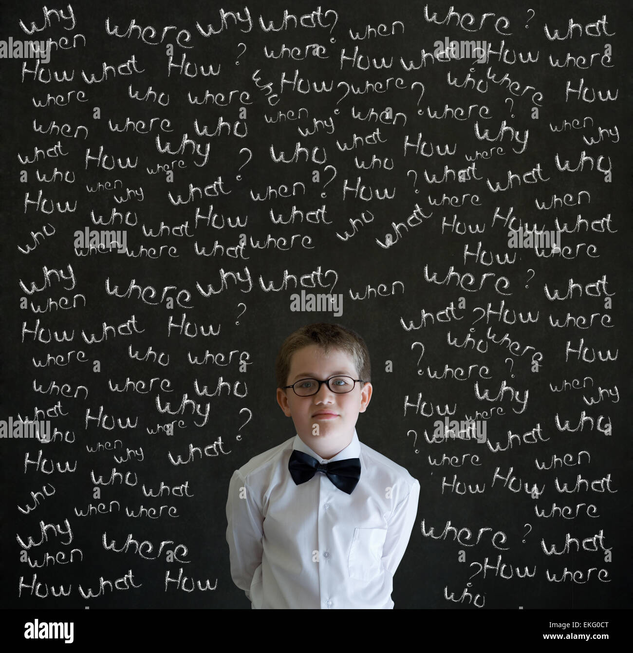 Thinking boy dressed as business man with chalk questions Stock Photo ...
