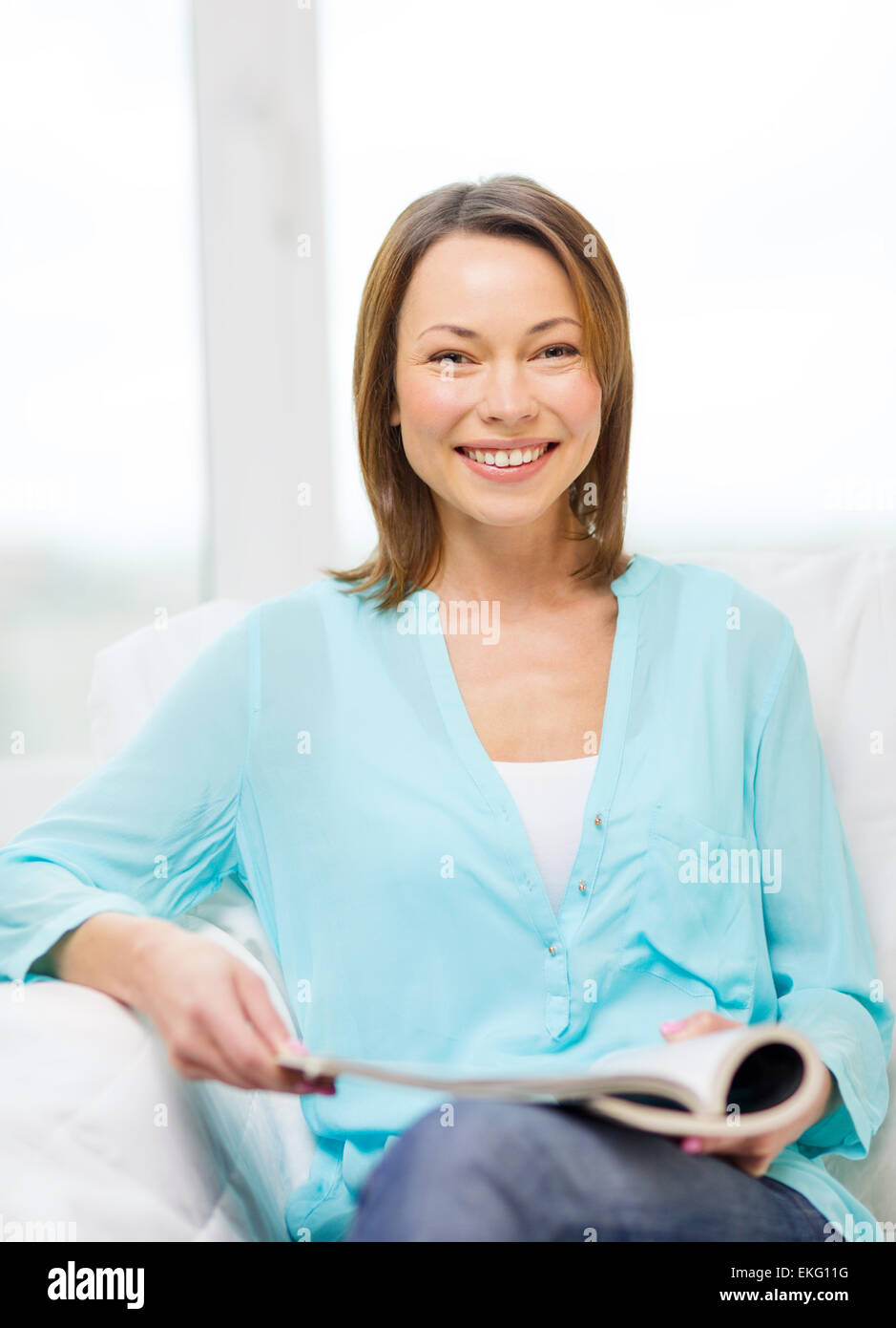 smiling woman reading magazine at home Stock Photo - Alamy