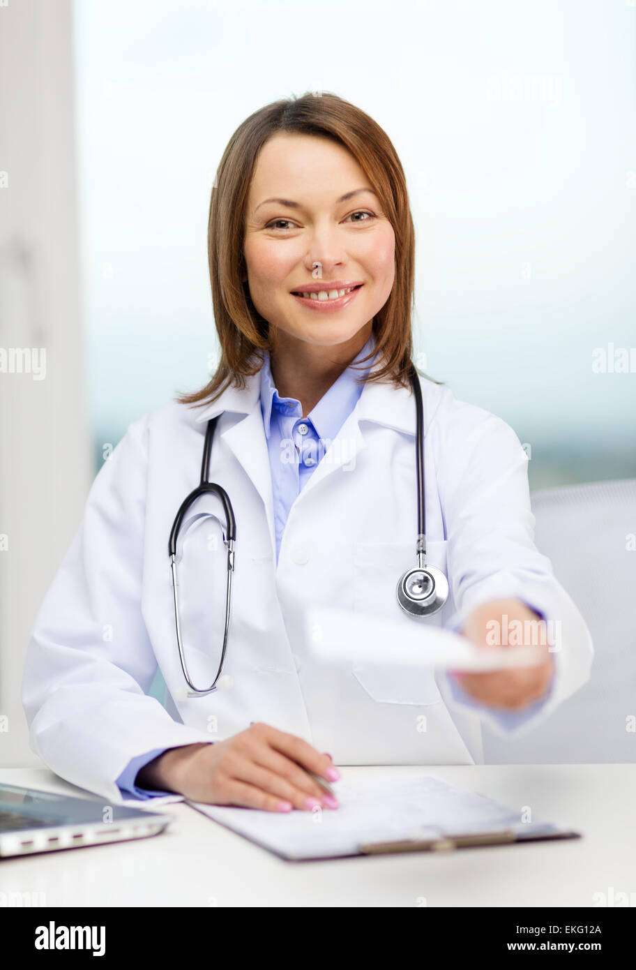 smiling doctor with laptop computer and clipboard Stock Photo - Alamy