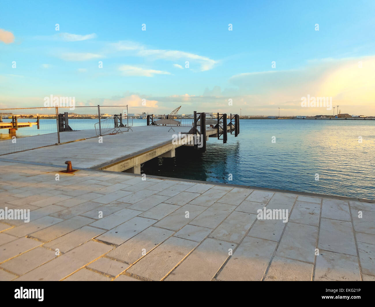 Pier at the port into the sunset Stock Photo - Alamy