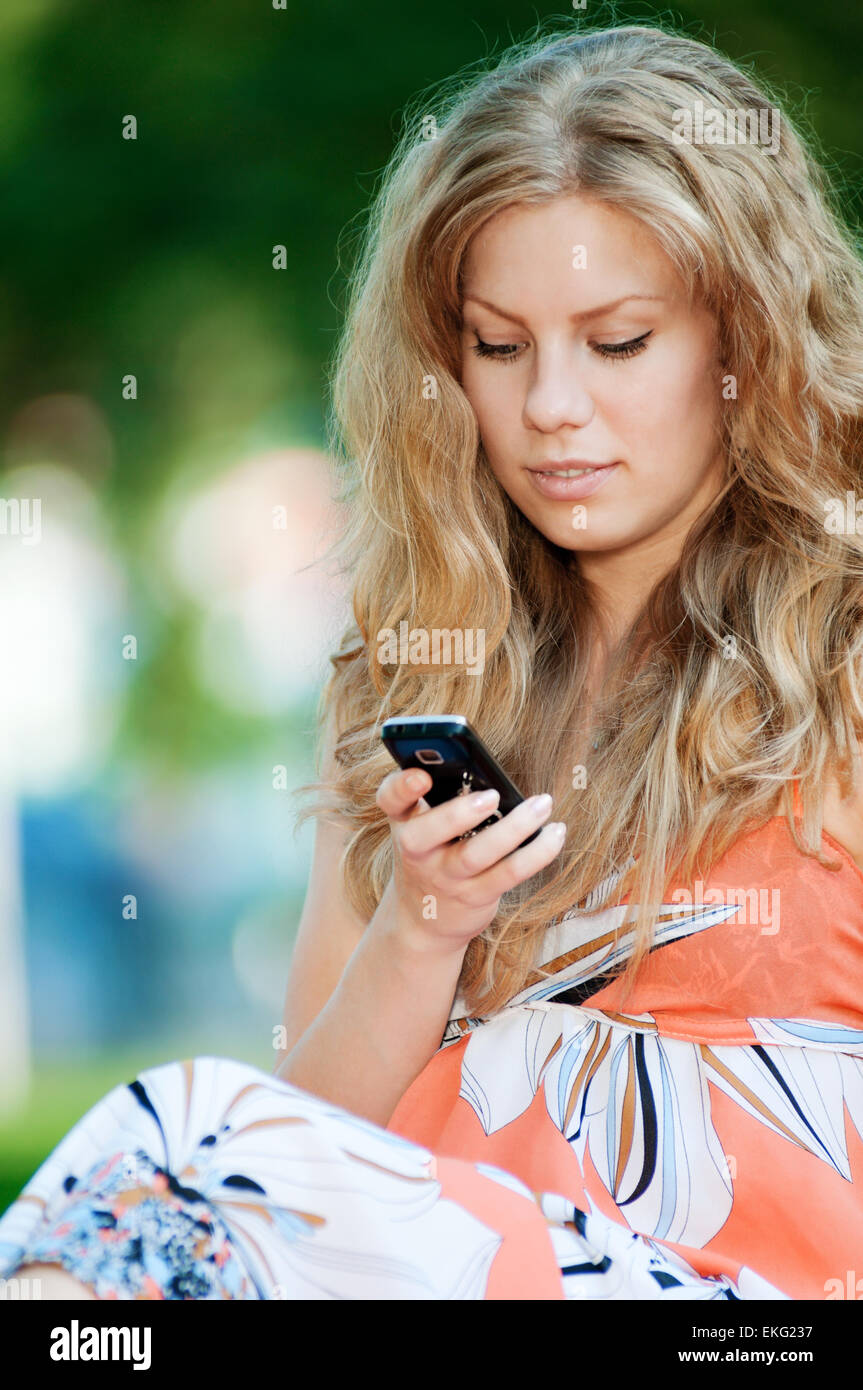 Woman texting on mobile phone Stock Photo - Alamy