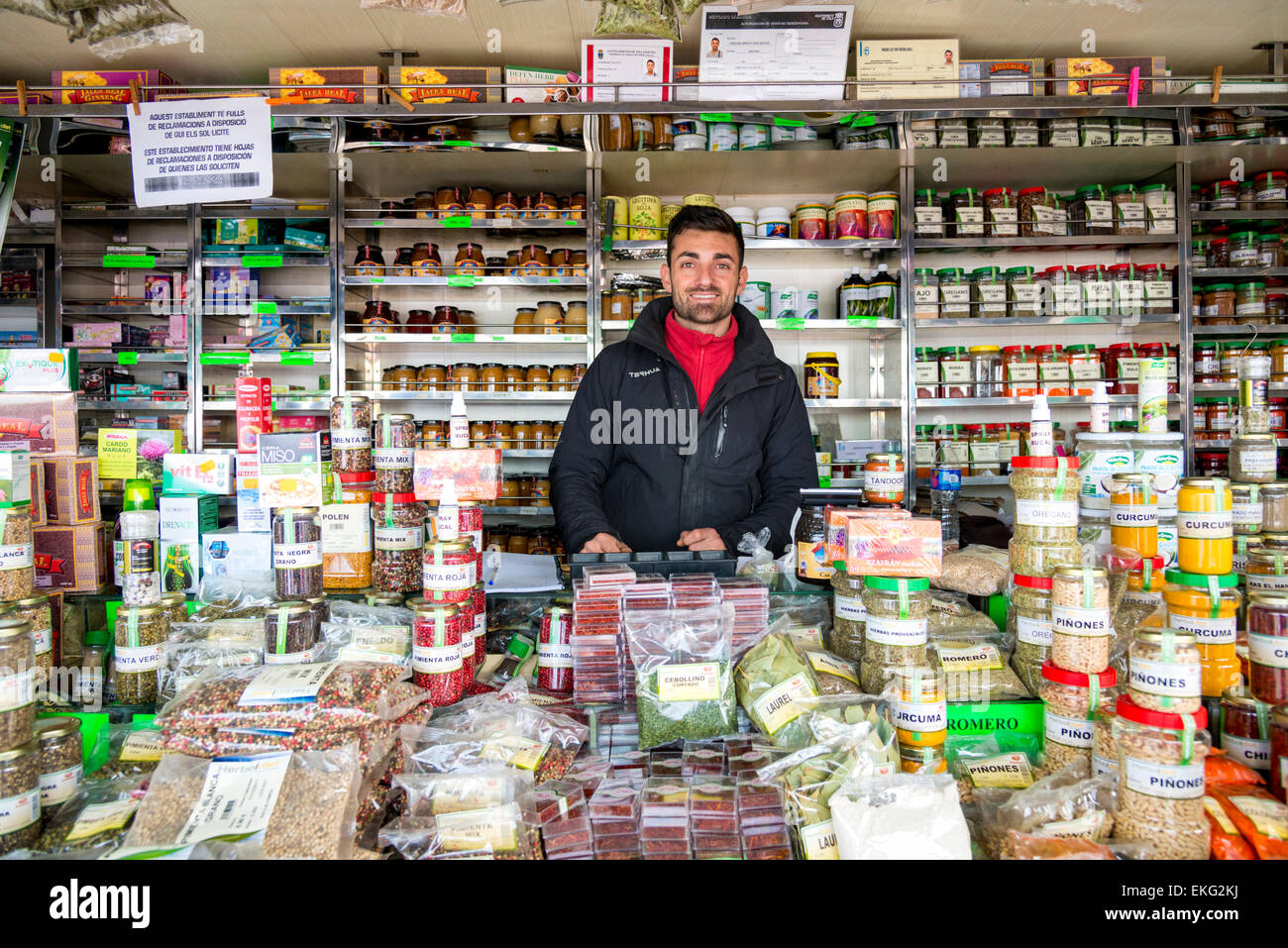 A portrait of a market trader in his market stall selling delicatessen ...