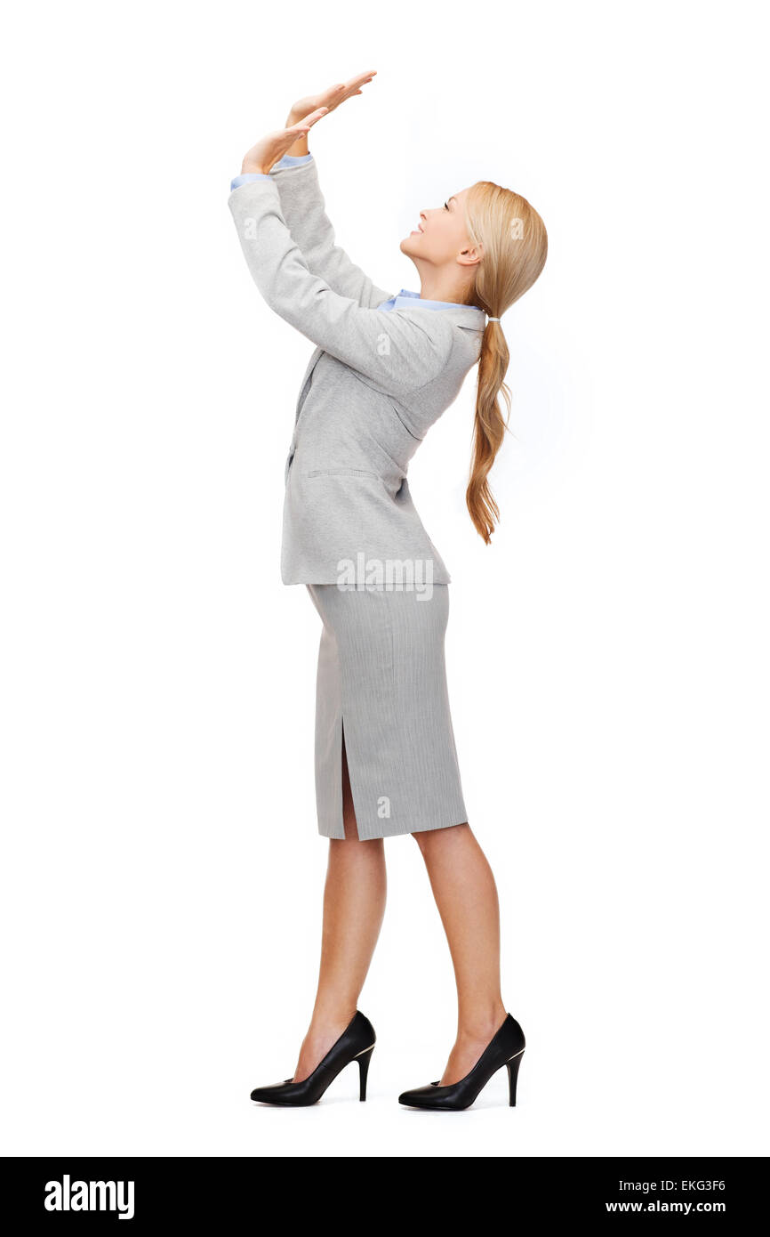 businesswoman pushing up something imaginary Stock Photo - Alamy