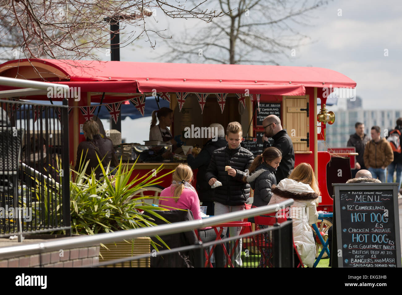 People eating outside a strret food stand outside the Tower Hotel ...