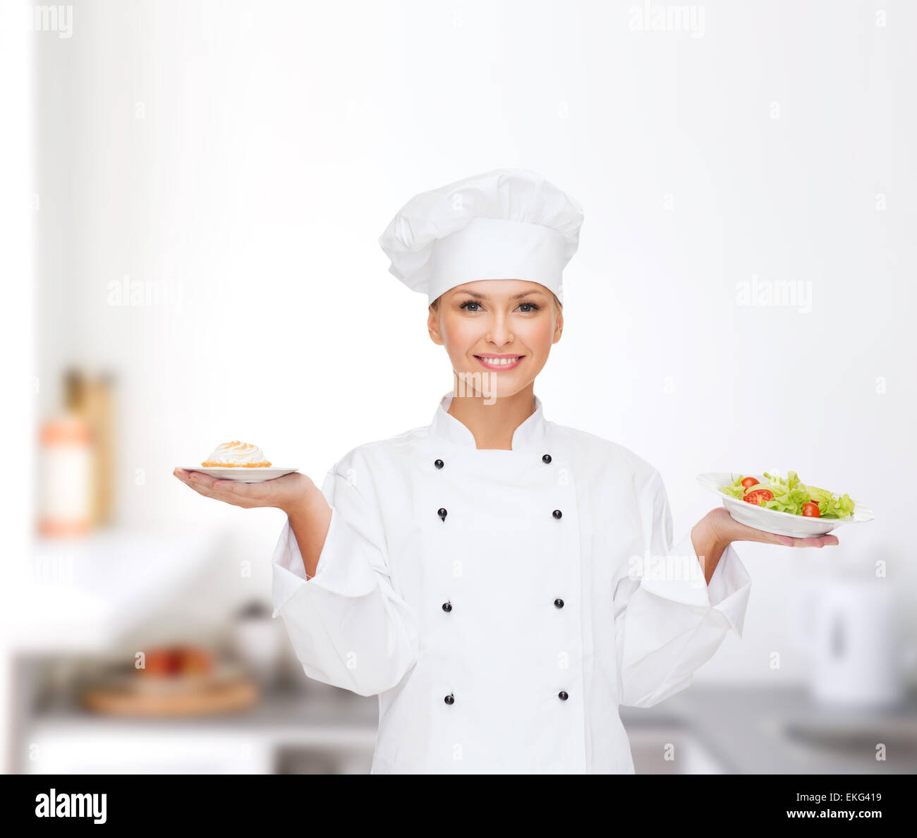 smiling female chef with salad and cake on plates Stock Photo - Alamy