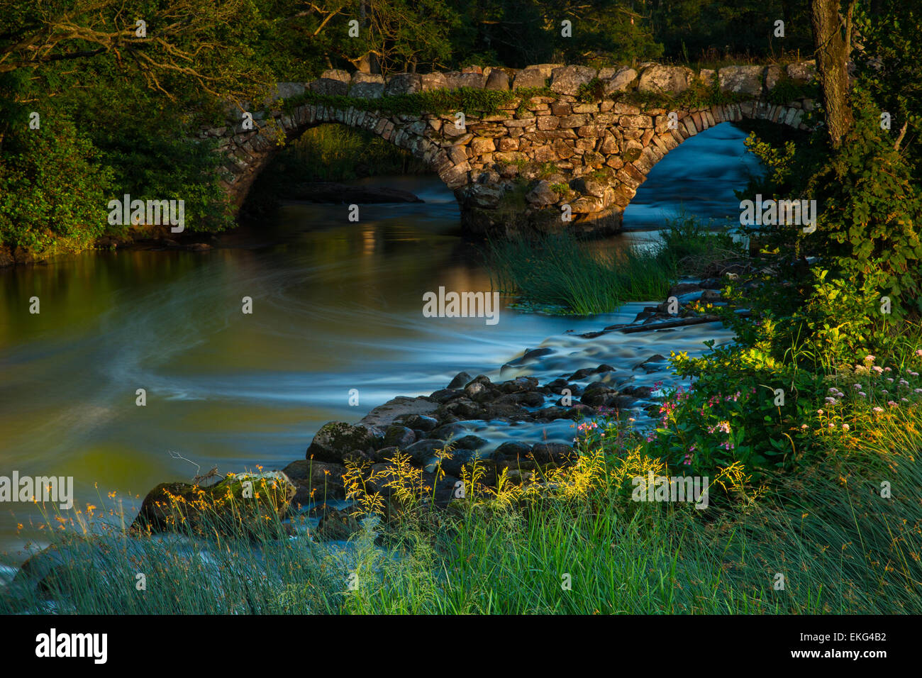 A stone bridge over a small river Stock Photo - Alamy