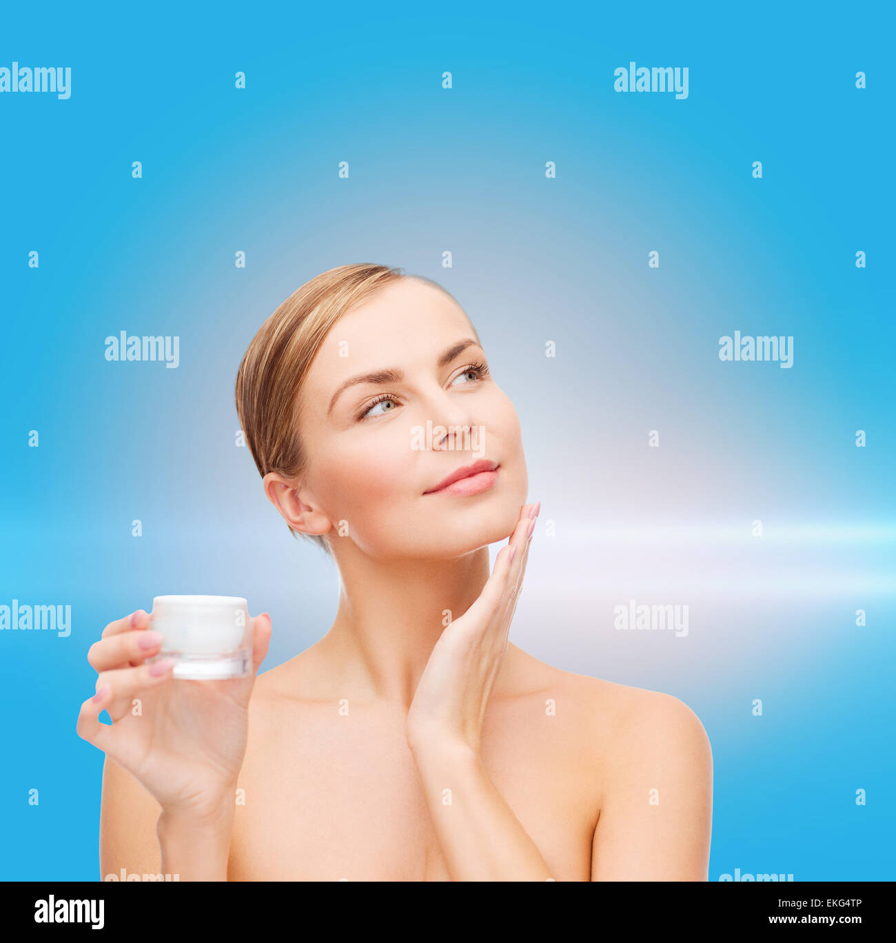 woman applying cream on her skin Stock Photo - Alamy