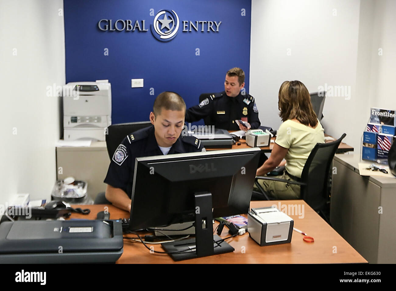 A CBP officer conducts a Global Entry interview at the Ronald Reagan ...