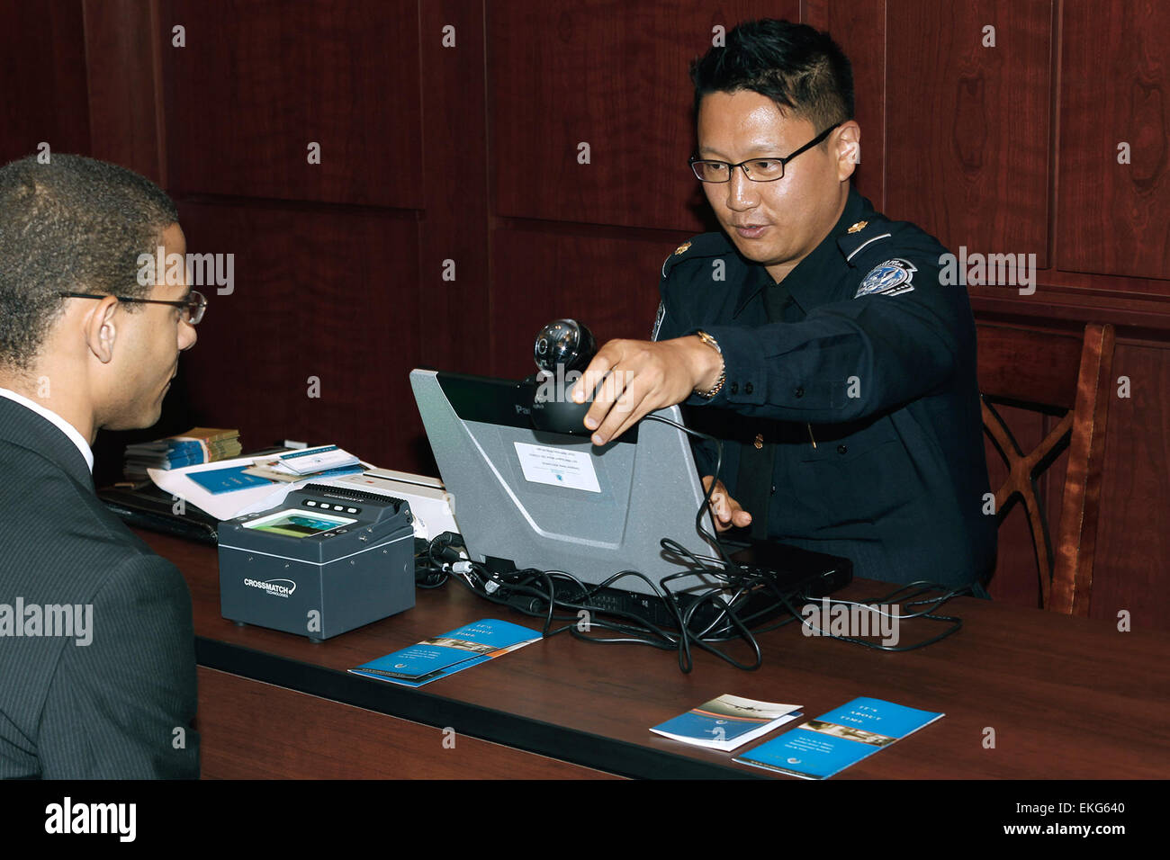 On July 23, 2013, a CBP officer captures biometric information, such as ...