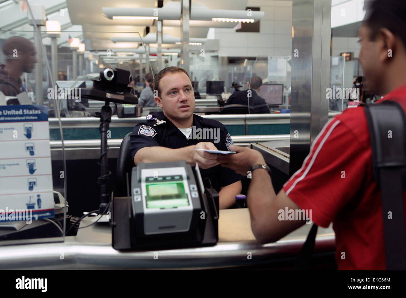 A CBP officer at Newark International Airport processes an incoming ...