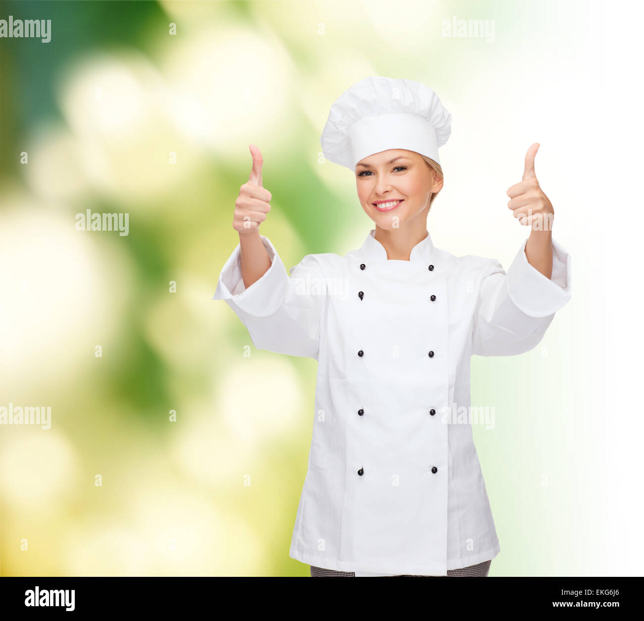 smiling female chef showing thumbs up Stock Photo - Alamy
