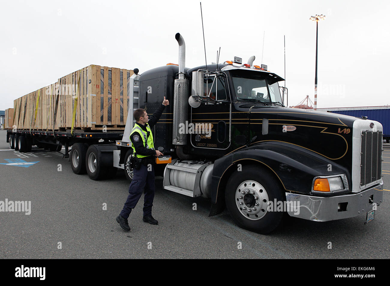 A U.S. Customs and Border Protection officer signals 'good to go' after ...