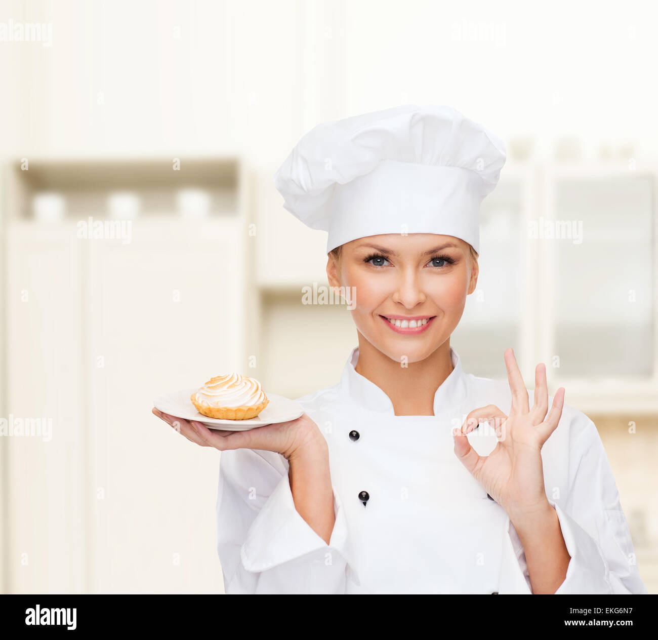smiling female chef with cake on plate Stock Photo - Alamy
