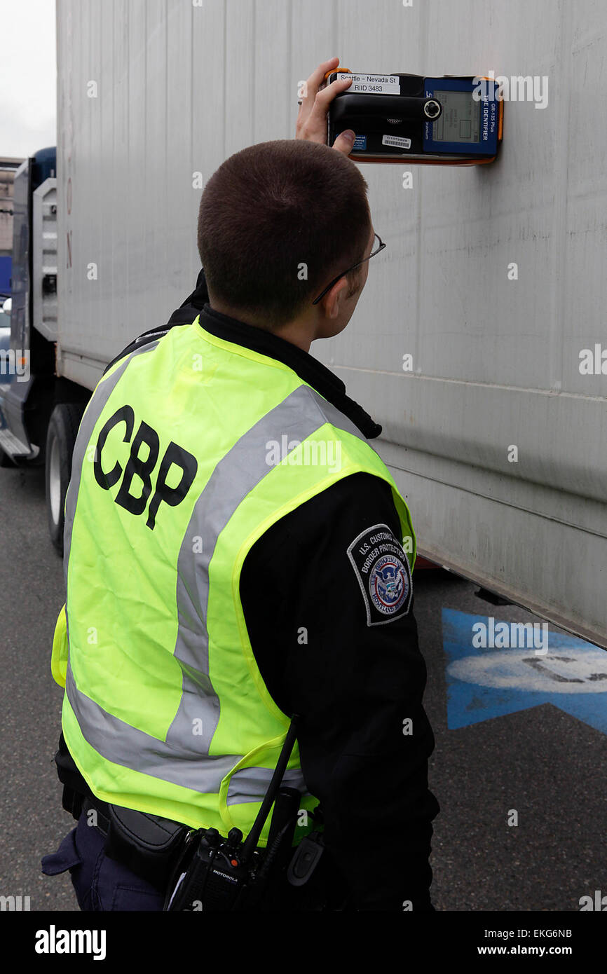 A U.S. Customs and Border Protection officer inspects a vehicle using ...