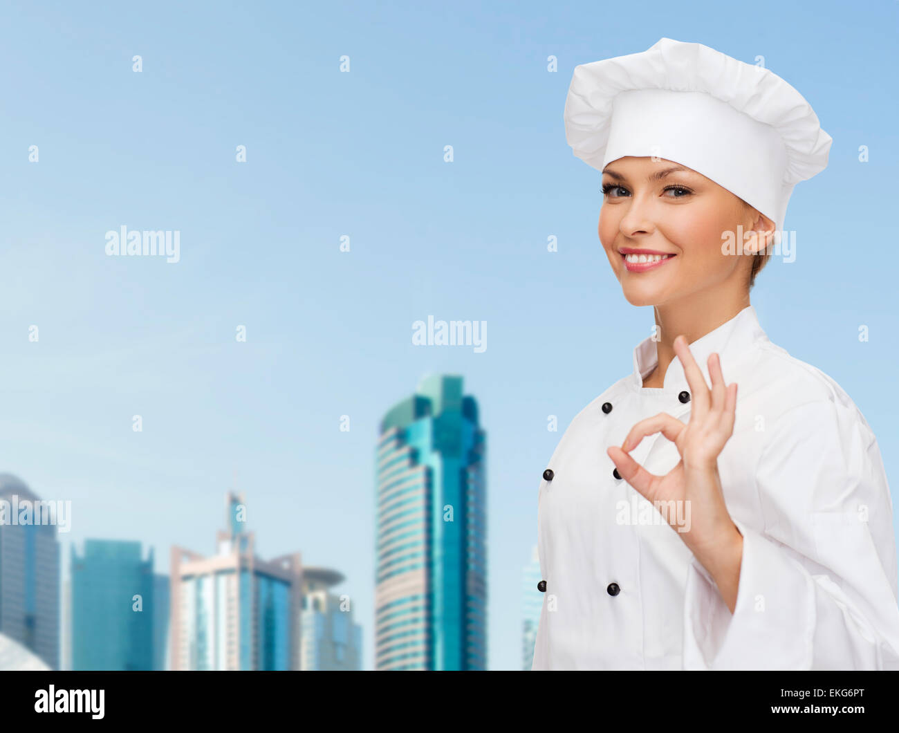 smiling female chef showing ok hand sign Stock Photo - Alamy