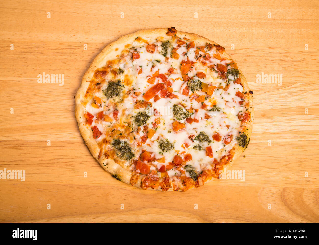 A whole vegetable pizza on a wood counter Stock Photo - Alamy