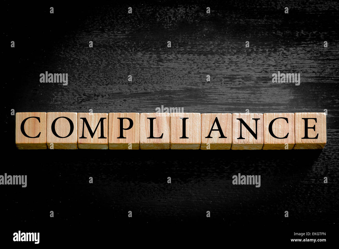 Word COMPLIANCE. Wooden small cubes with letters isolated on black ...