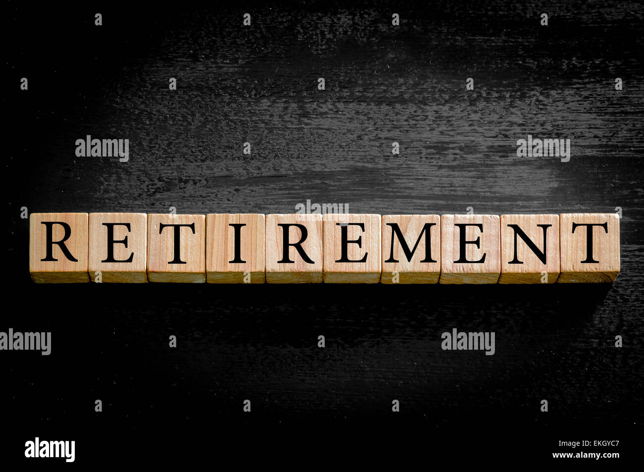 Word RETIREMENT. Wooden small cubes with letters isolated on black ...