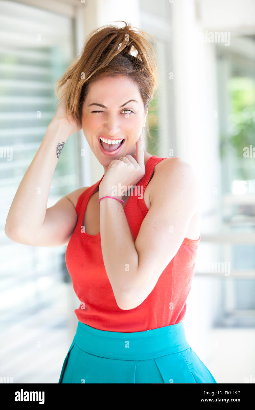 Colorful young woman smiling Stock Photo - Alamy