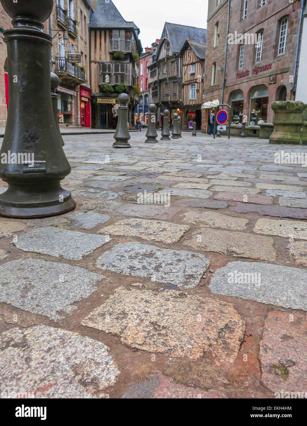 Old tiles on pavement and short poles in old French city, low angle ...