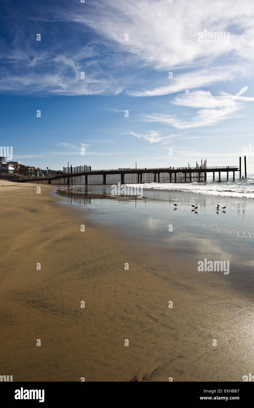 The photo shows the construction of a border fence and pier extending ...