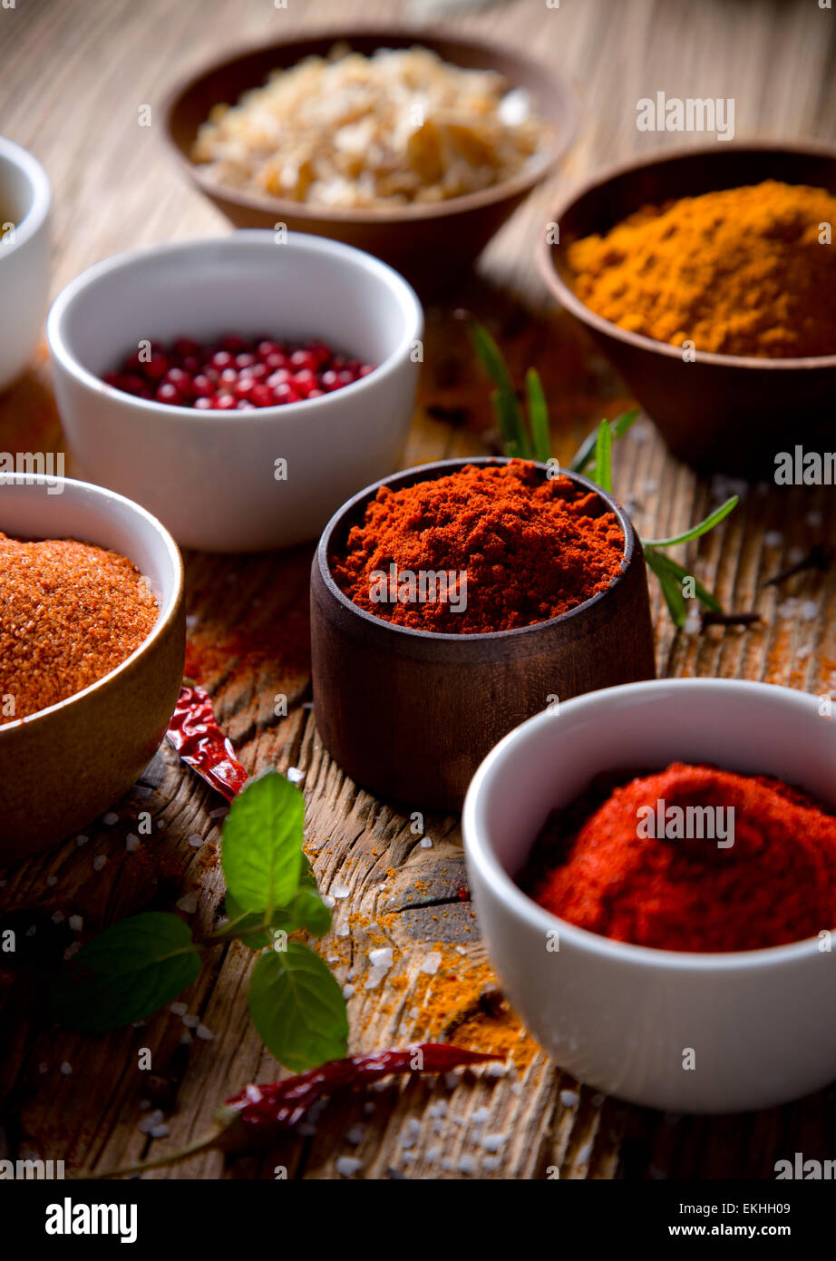 Assorted spices on wooden background Stock Photo - Alamy