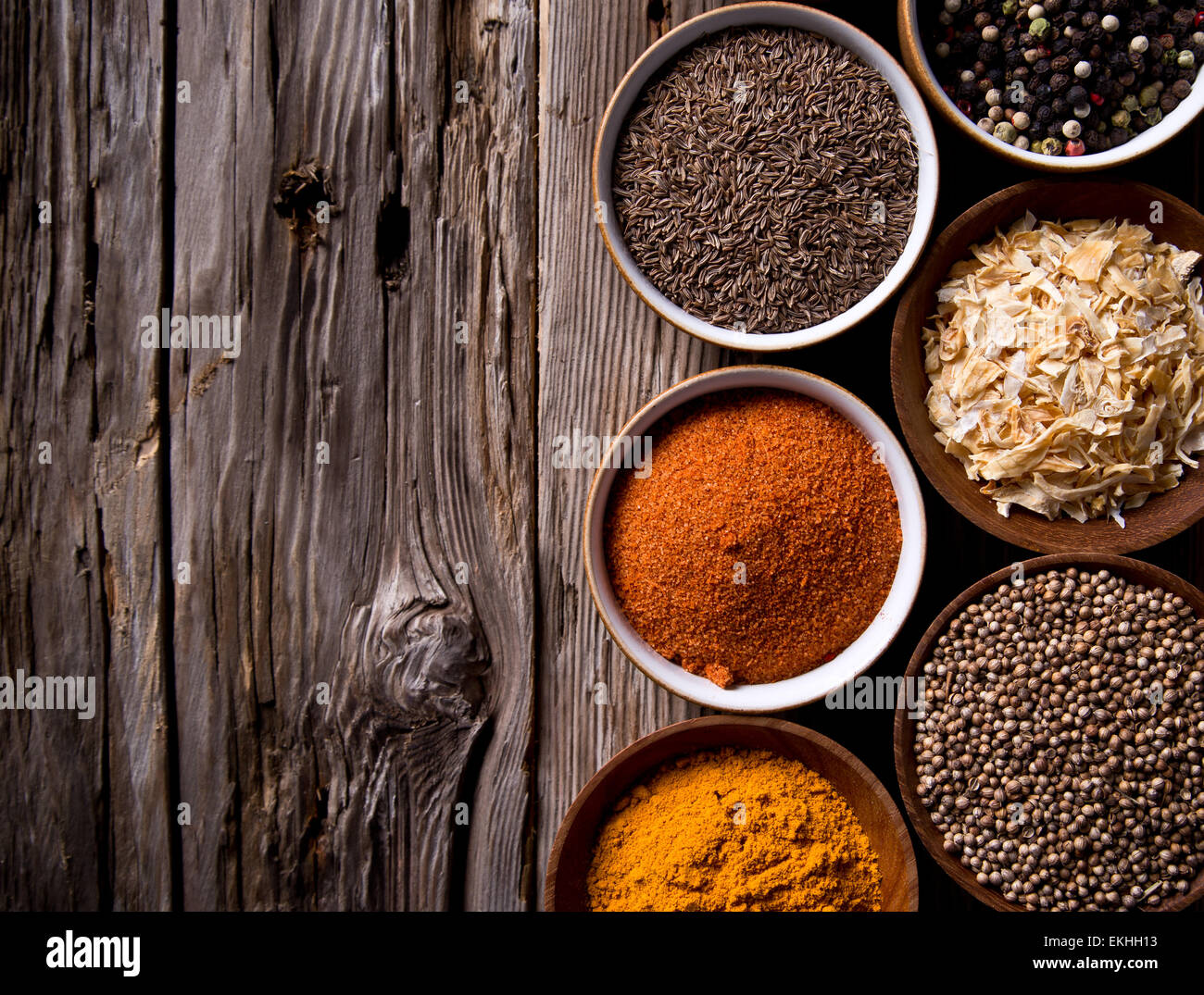 Assorted spices on wooden background Stock Photo - Alamy