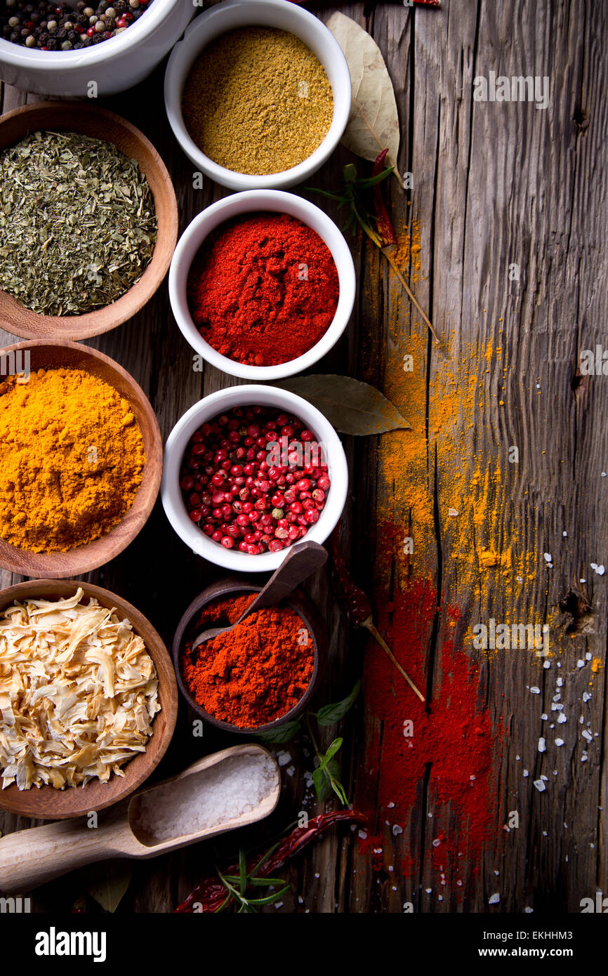 Assorted spices on wooden background Stock Photo - Alamy