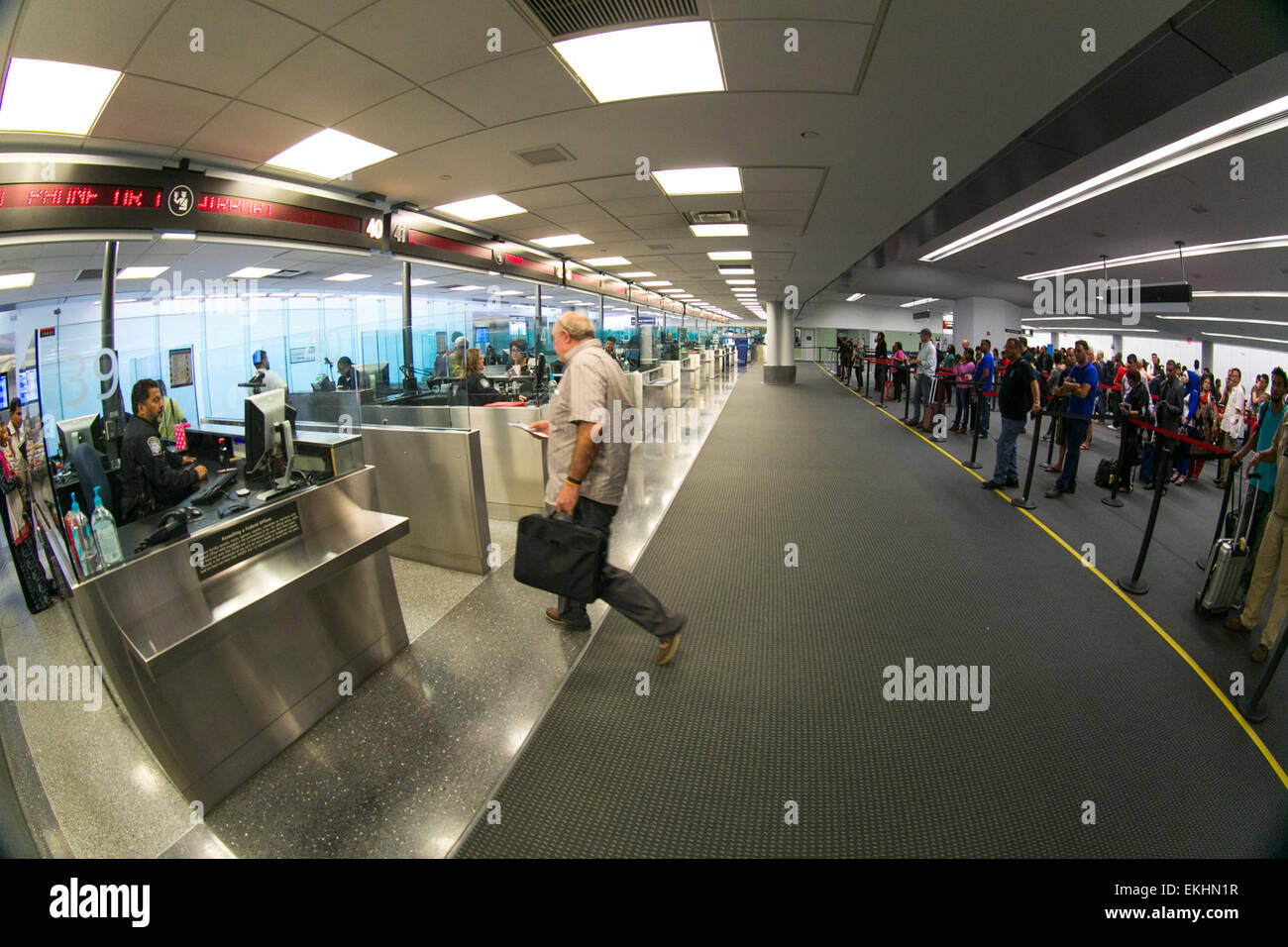 U.S. Customs and Border Protection officers process passengers at an ...