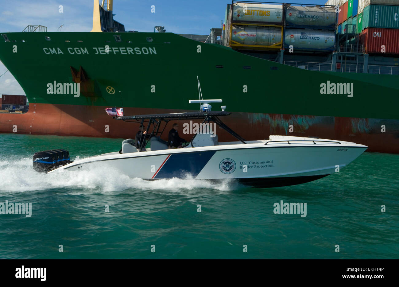 CBP Air and Marine patrols past shipping containers on water, with ...